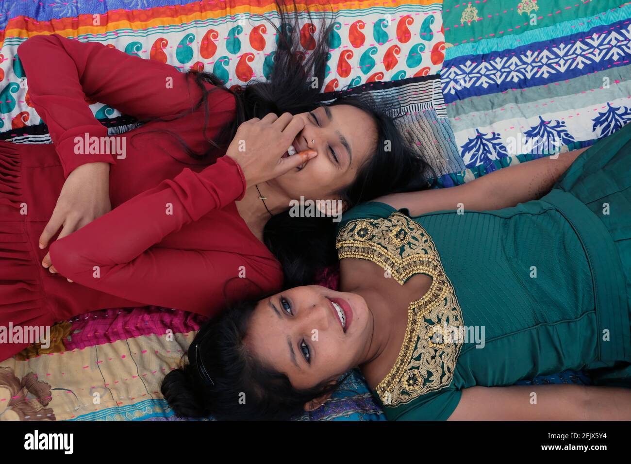 High angle shot of two female South Asian friends in traditional ...