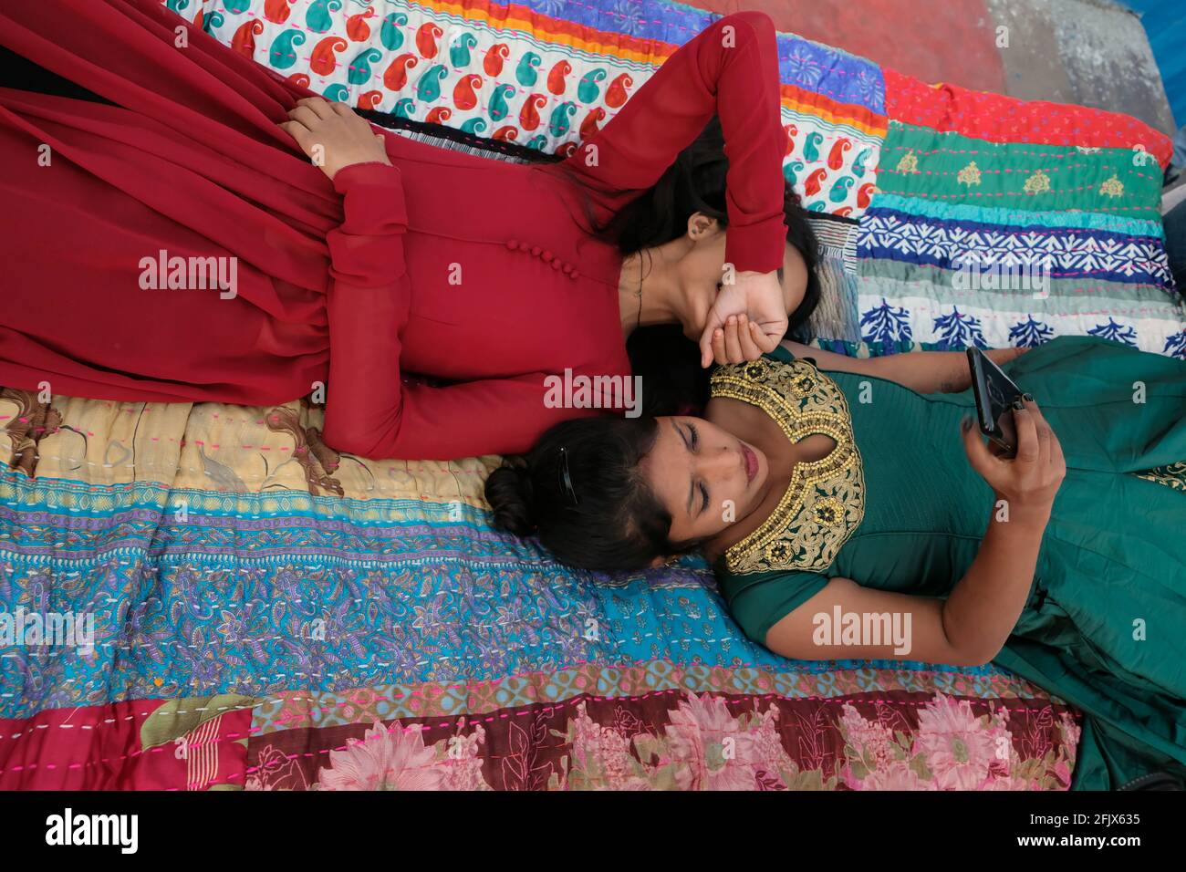 High angle shot of two female South Asian friends in traditional ...