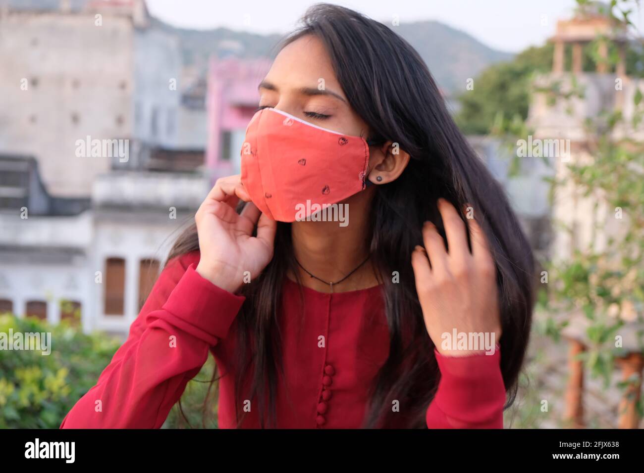 Closeup shot of a South Asian female with a red mask Stock Photo - Alamy
