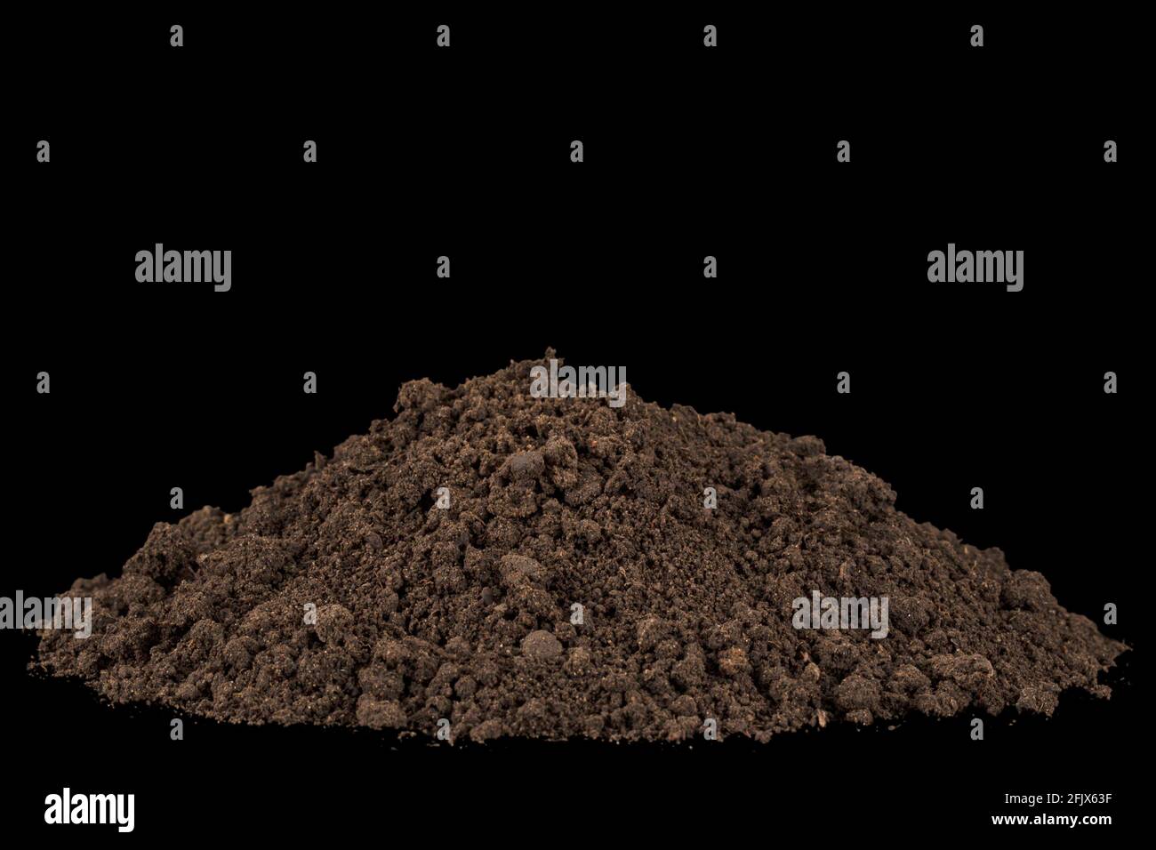Heap of soil isolated on black background Stock Photo - Alamy