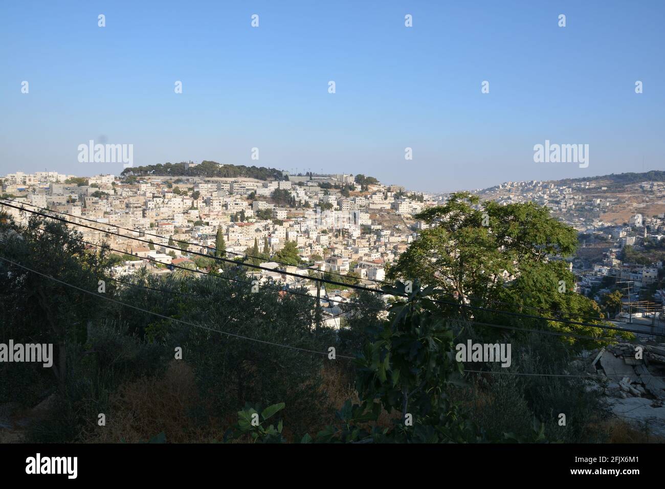 Aerial shot of a town on the hill with trees in the foreground Stock ...