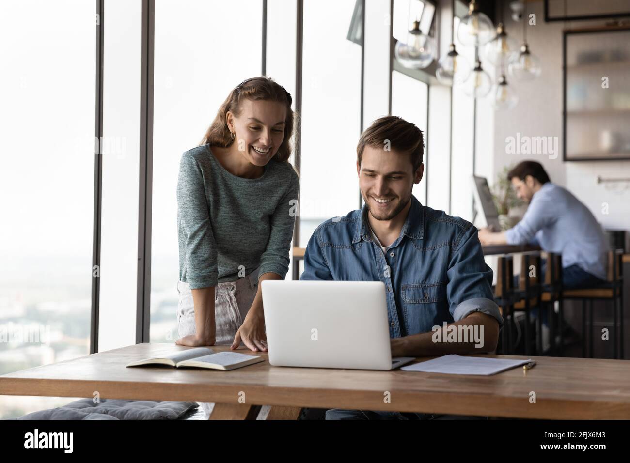 Happy colleagues brainstorm on computer at workplace Stock Photo - Alamy