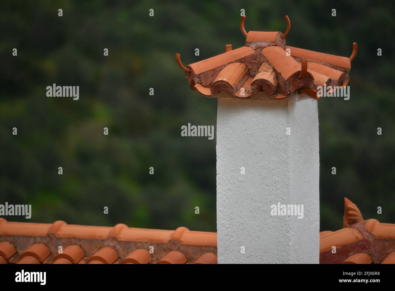 Traditional red clay rooftop and chimney on a rural house in Tyros ...