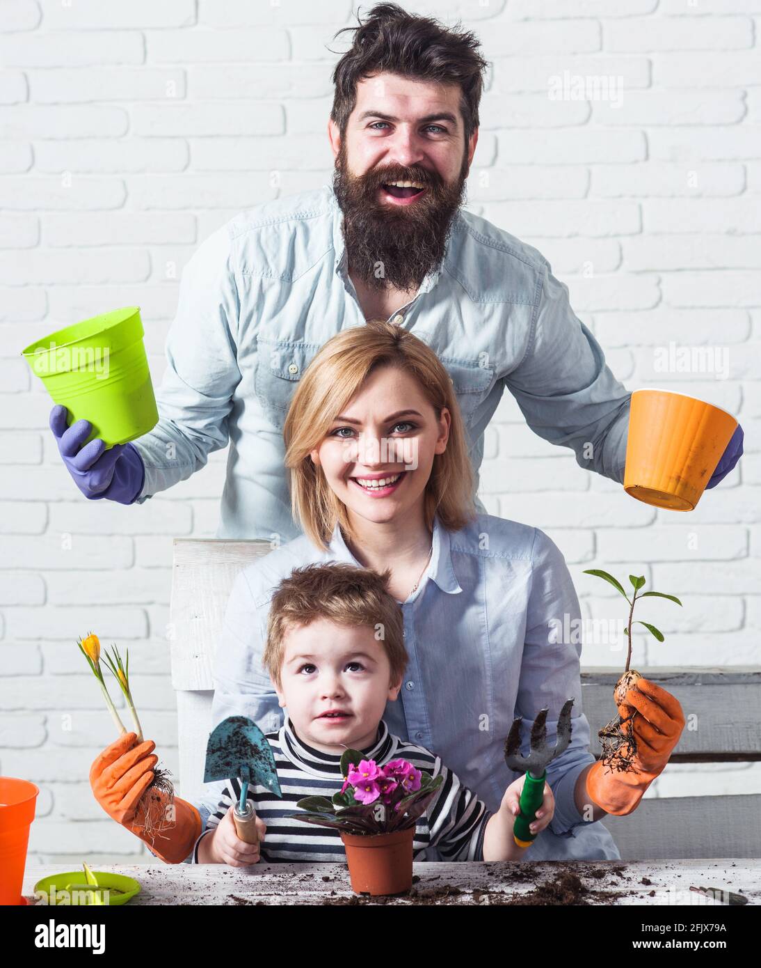 Family planting flowers together. Care for plants. Gardening concept ...