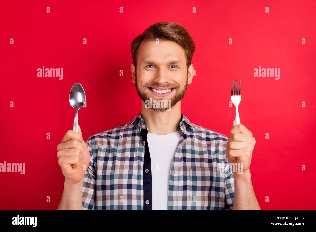 Photo of handsome hungry young gentleman dressed plaid shirt holding ...