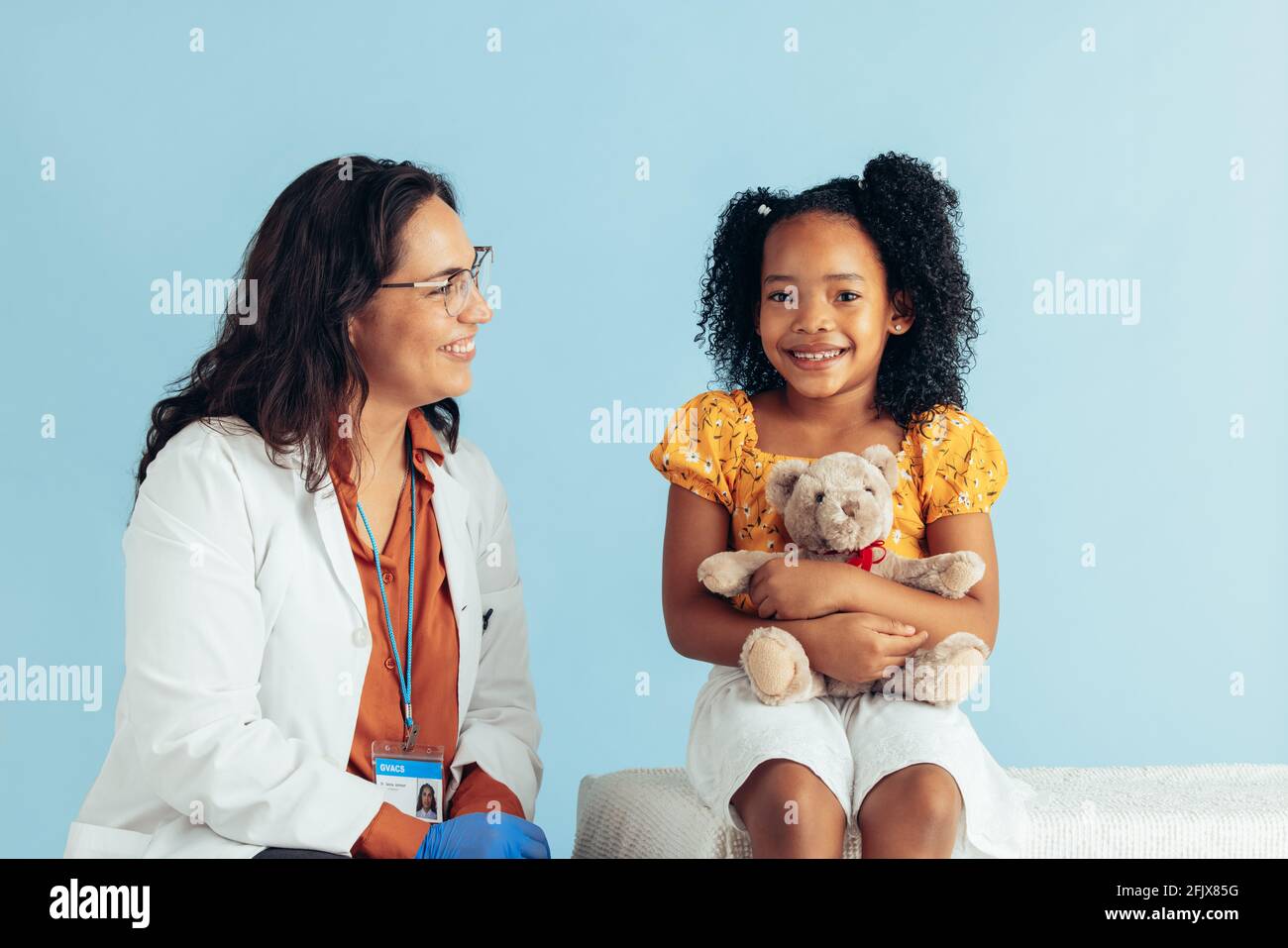 Doctor and girl patient girl in clinic. Smiling pediatrician with cute ...
