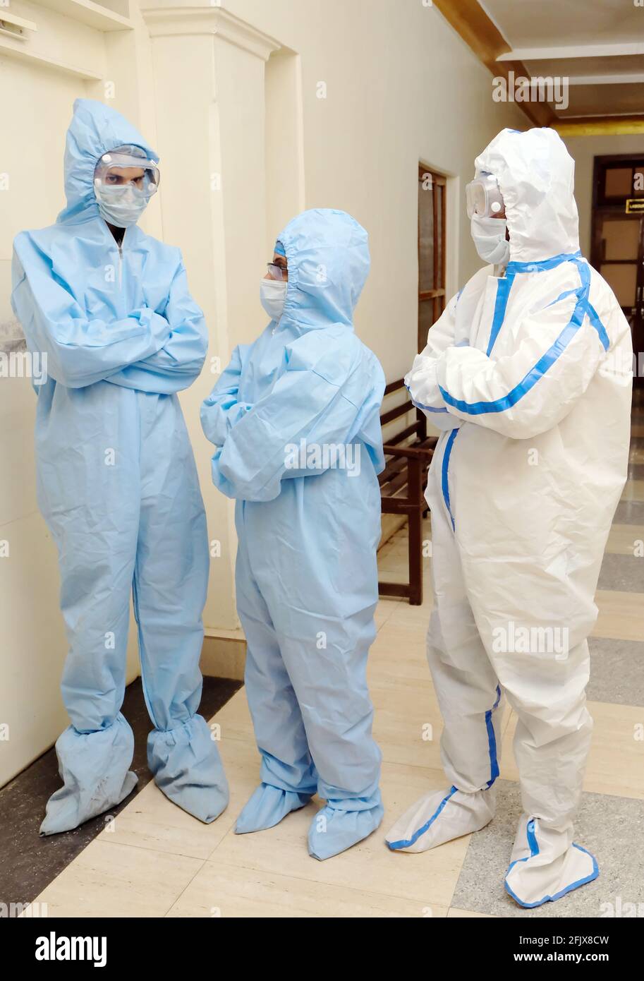 Vertical shot of the medical personnel in special protective costumes ...