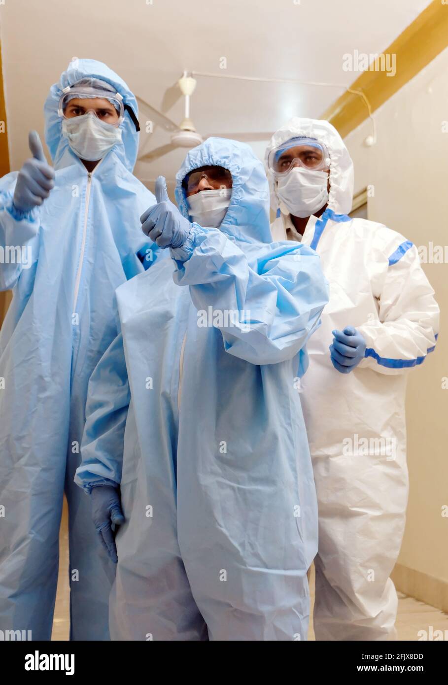 Vertical shot of the medical personnel in special protective costumes ...