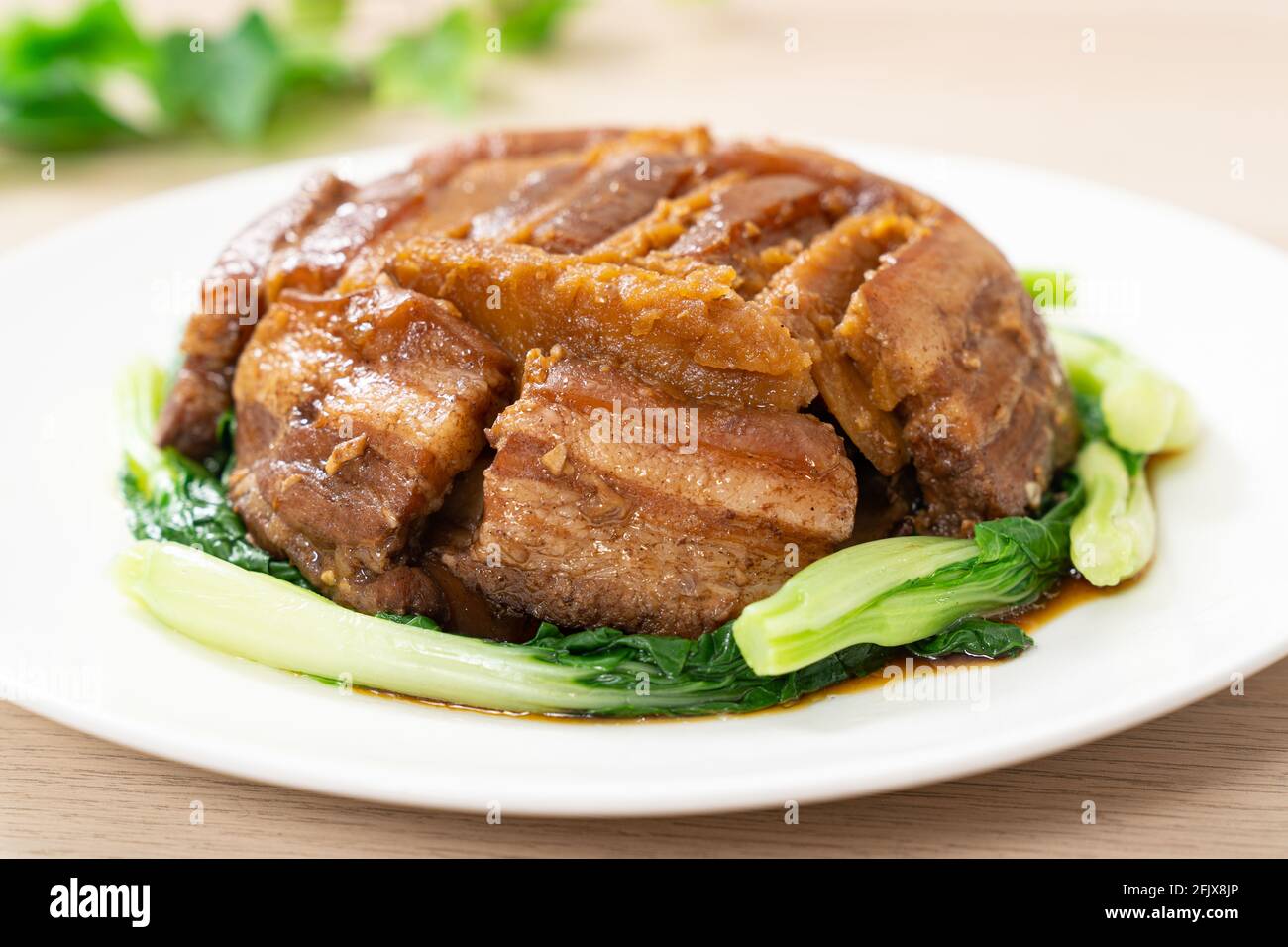 Braised pork belly with yam served with green vegetable Stock Photo - Alamy