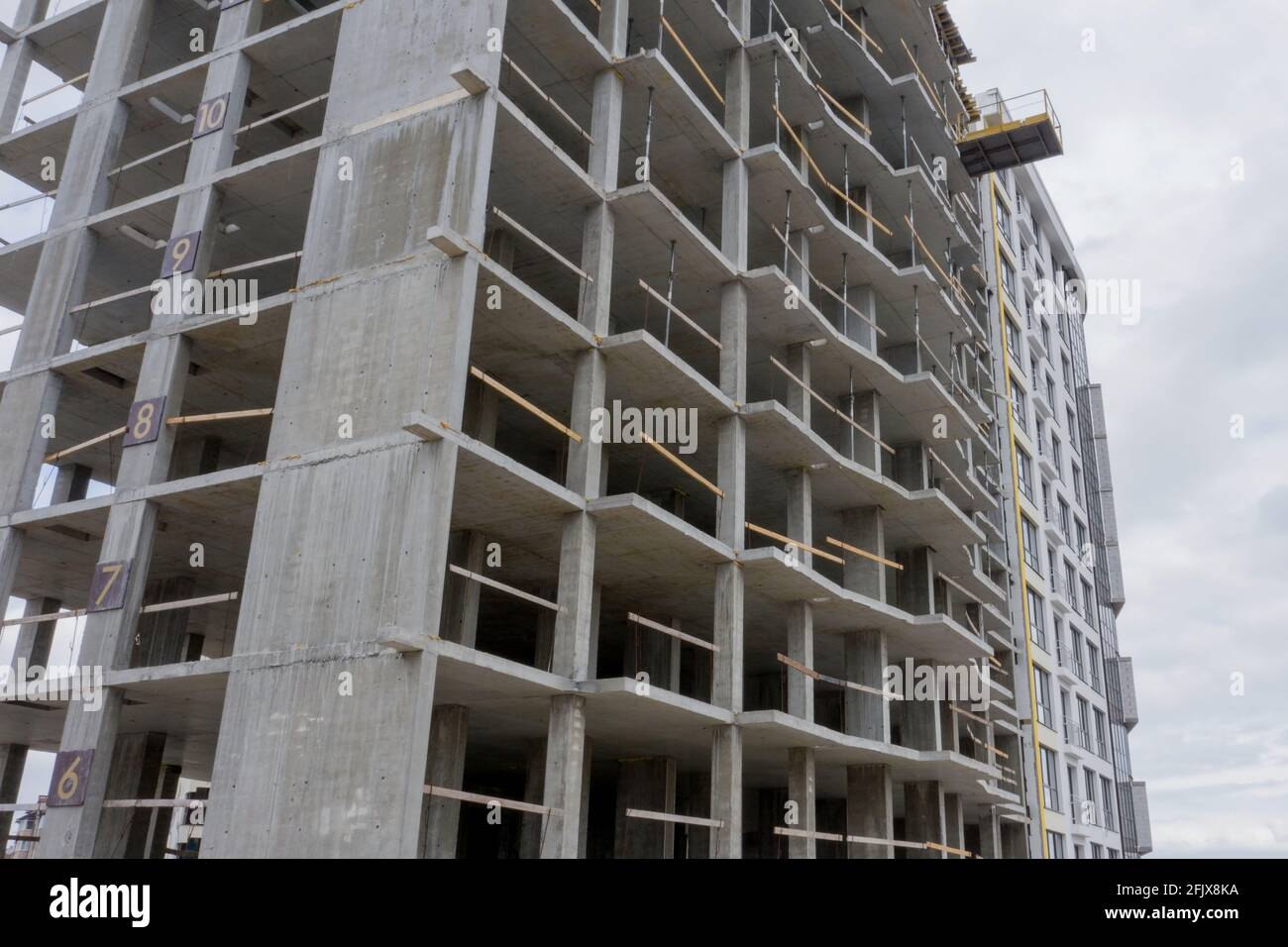 Aerial view of concrete frame of tall apartment building under ...