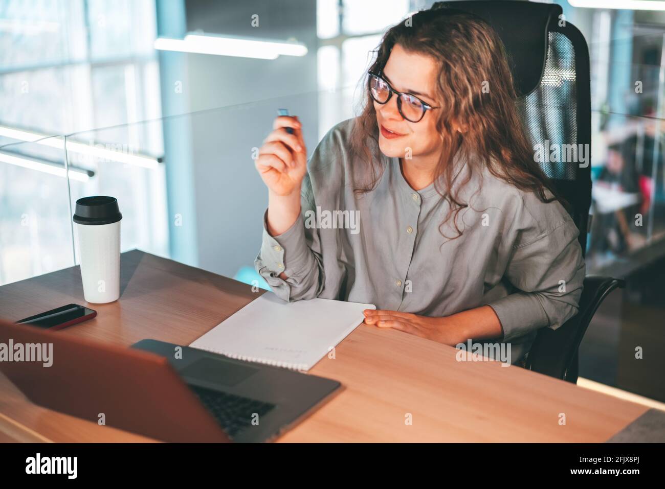 Girl making a video call at the office Stock Photo - Alamy