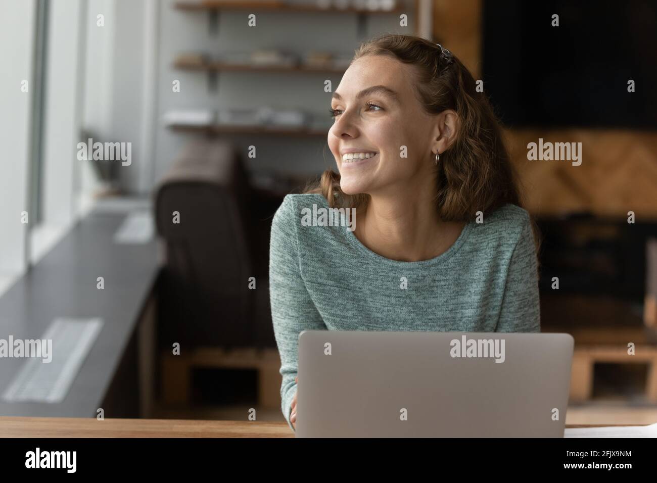 Happy female employee work on computer thinking visualizing Stock Photo ...