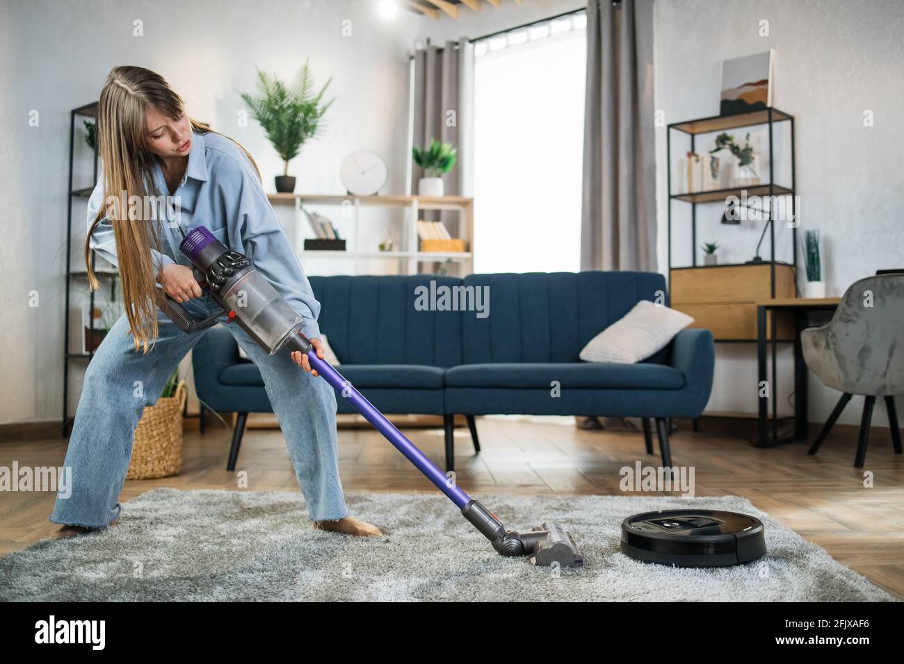 Woman doing chores using vacuum cleaner hi-res stock photography and ...