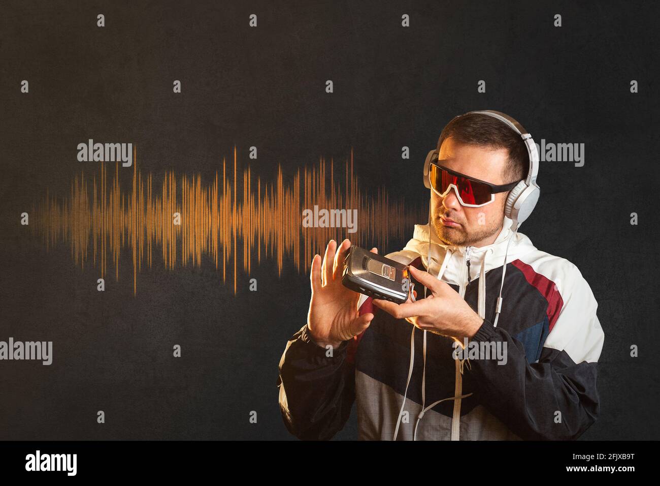 Radio day. Man listening music in headphones. Oldschool cassette player ...