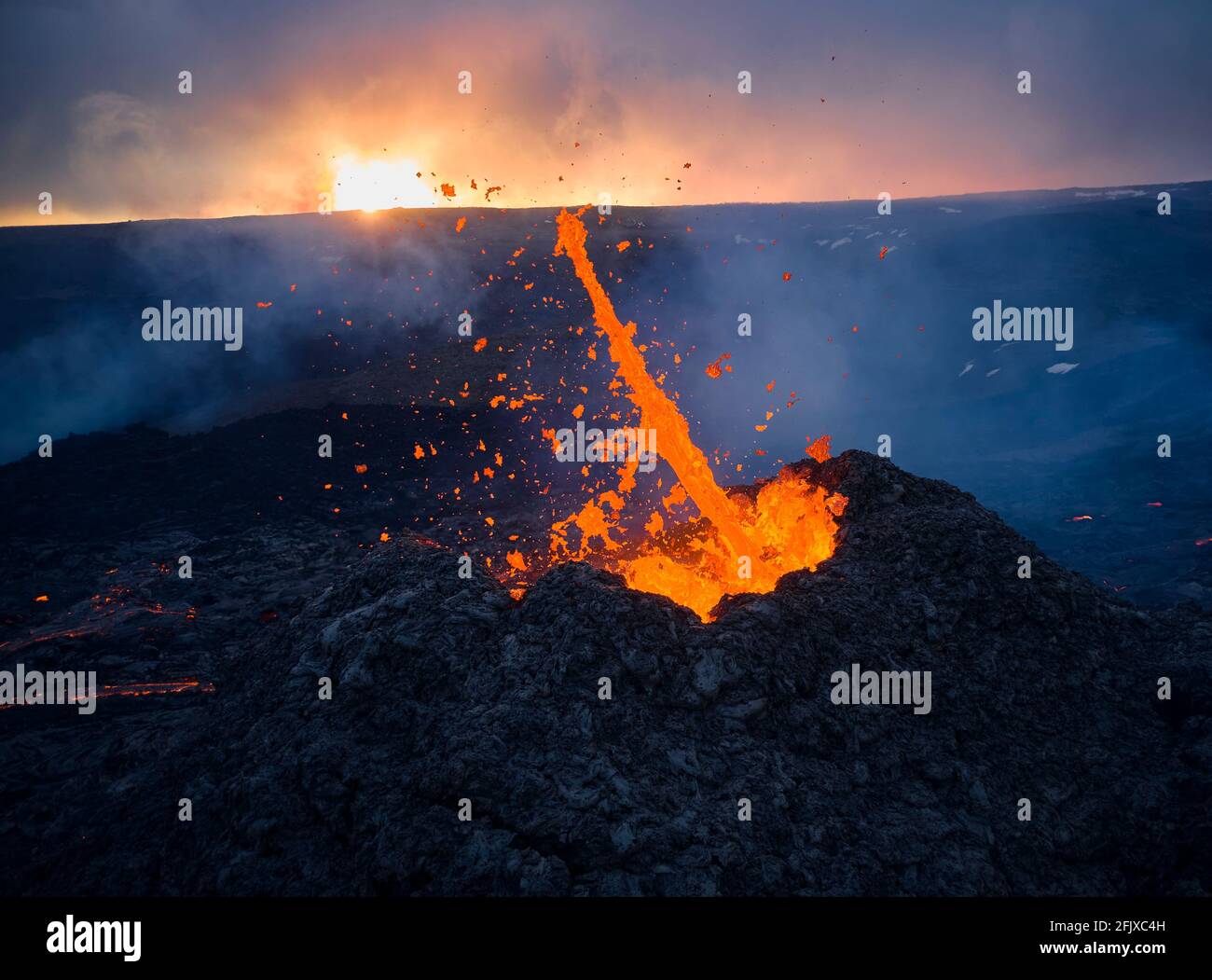 Burning hot lava splashing in volcano crater in overcast evening Stock ...