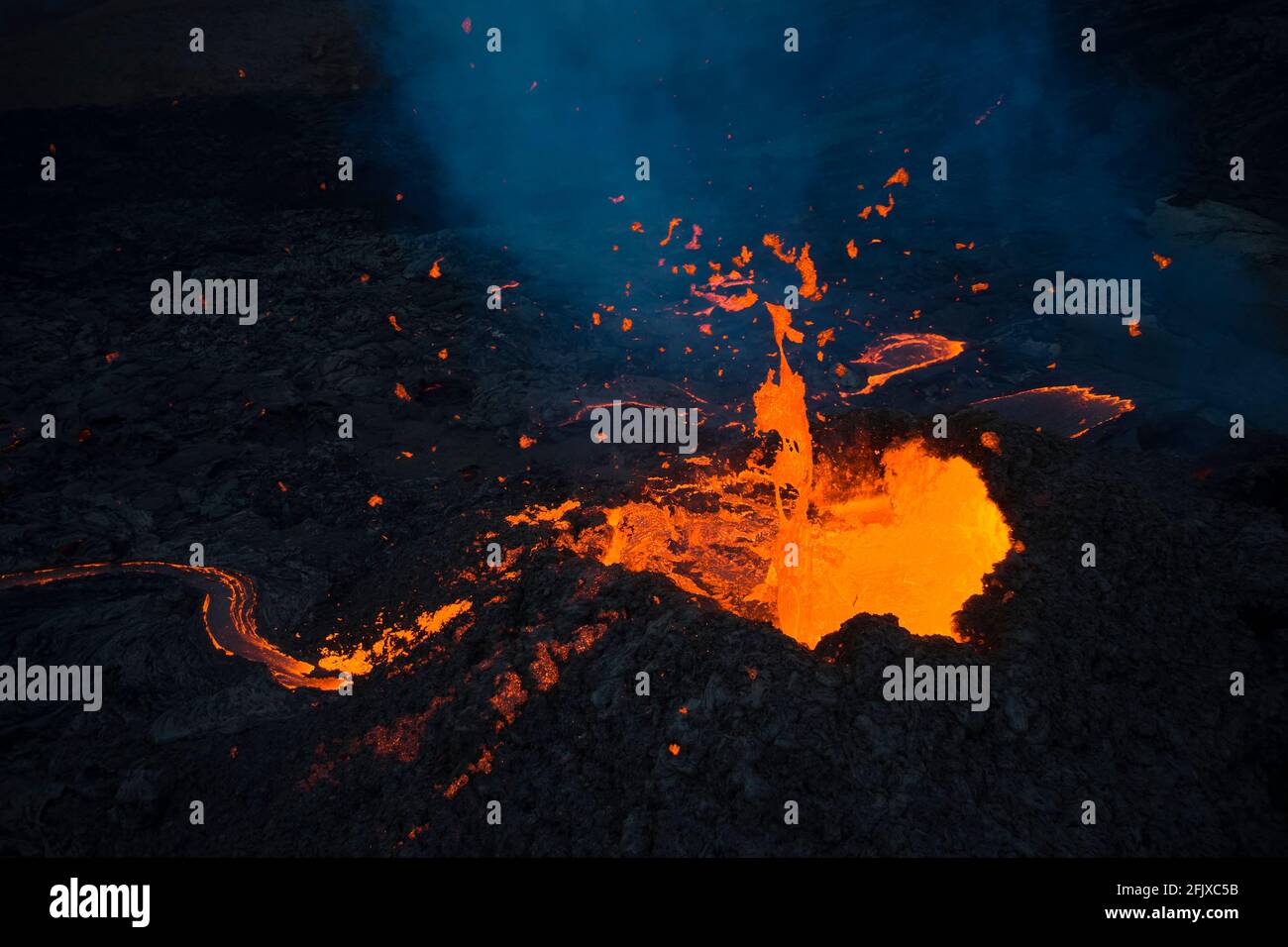 Burning lava flowing from active volcano crater Stock Photo - Alamy