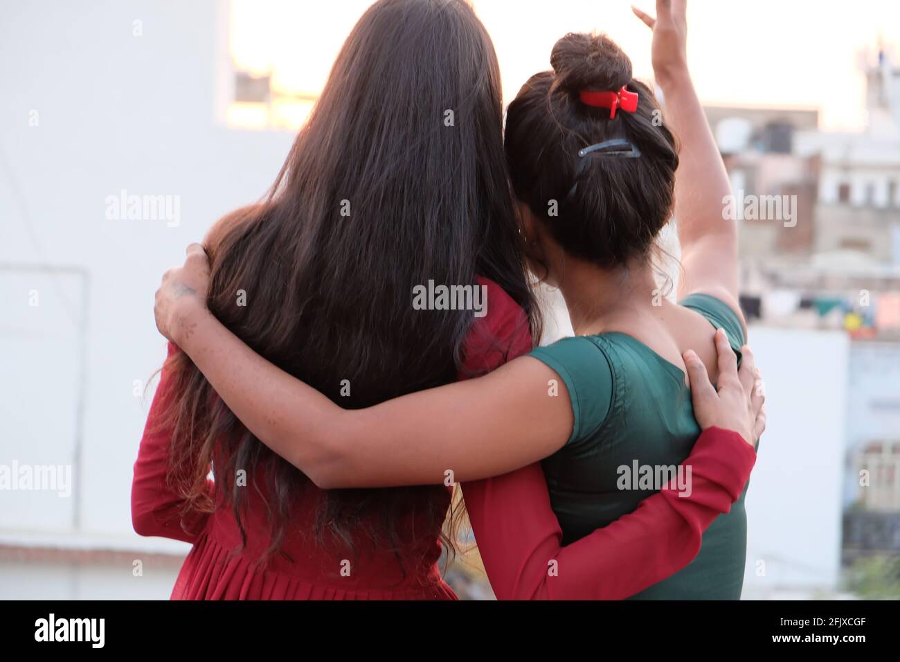 Back view of two young Indian females hugging each other Stock Photo ...