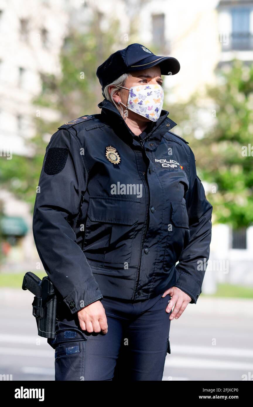 Police woman member of the security forces of Spain posing with a mask ...