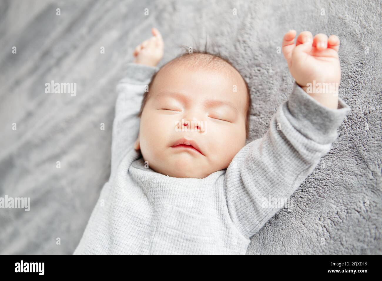Newborn baby touching his face hi-res stock photography and images - Alamy