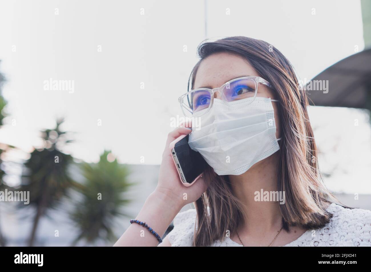 Young woman making a call with her cell phone Stock Photo - Alamy
