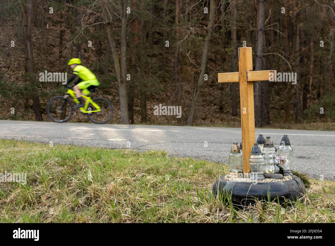 A roadside memorial cross with a candles commemorating the tragic death ...