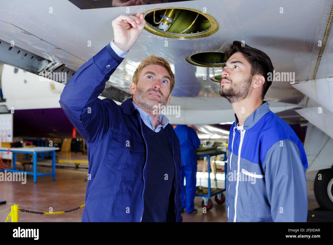 Engineers in jet aircraft hangar hi-res stock photography and images ...