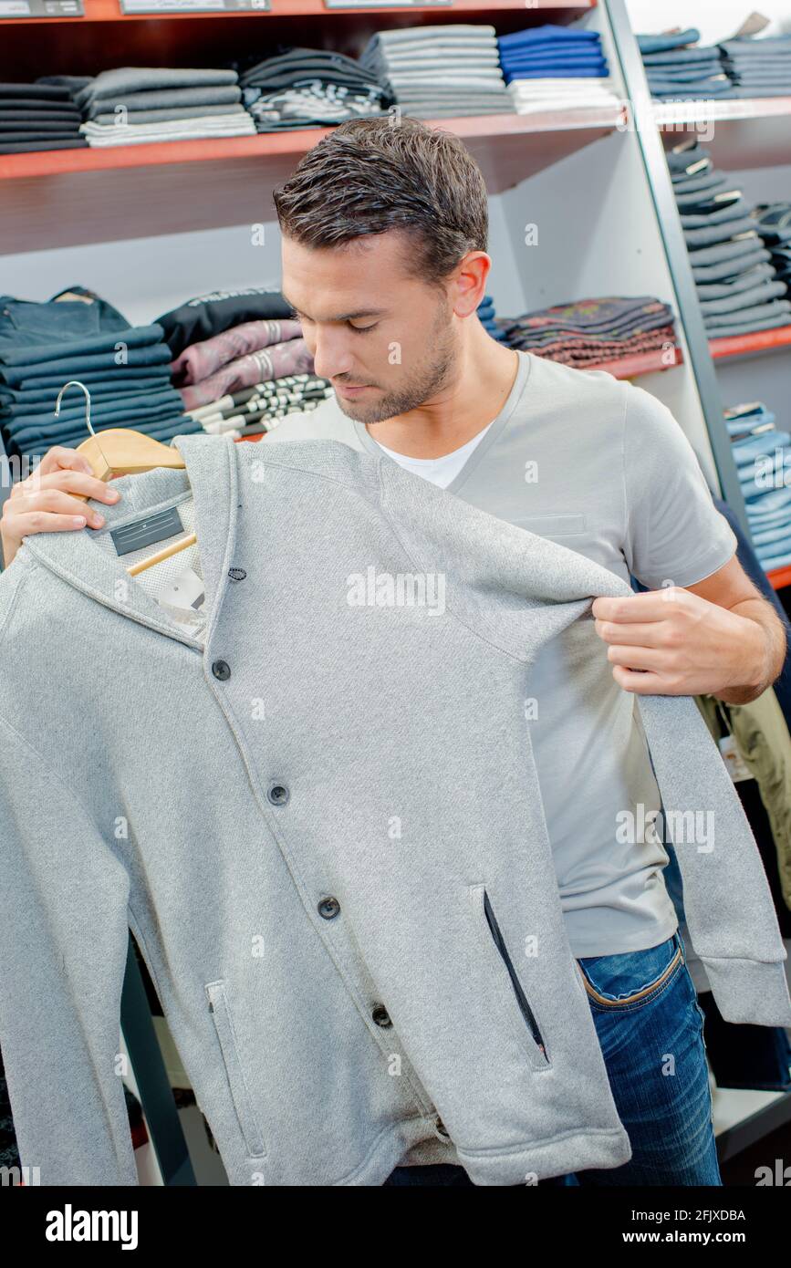 Man browsing the clothing section Stock Photo - Alamy