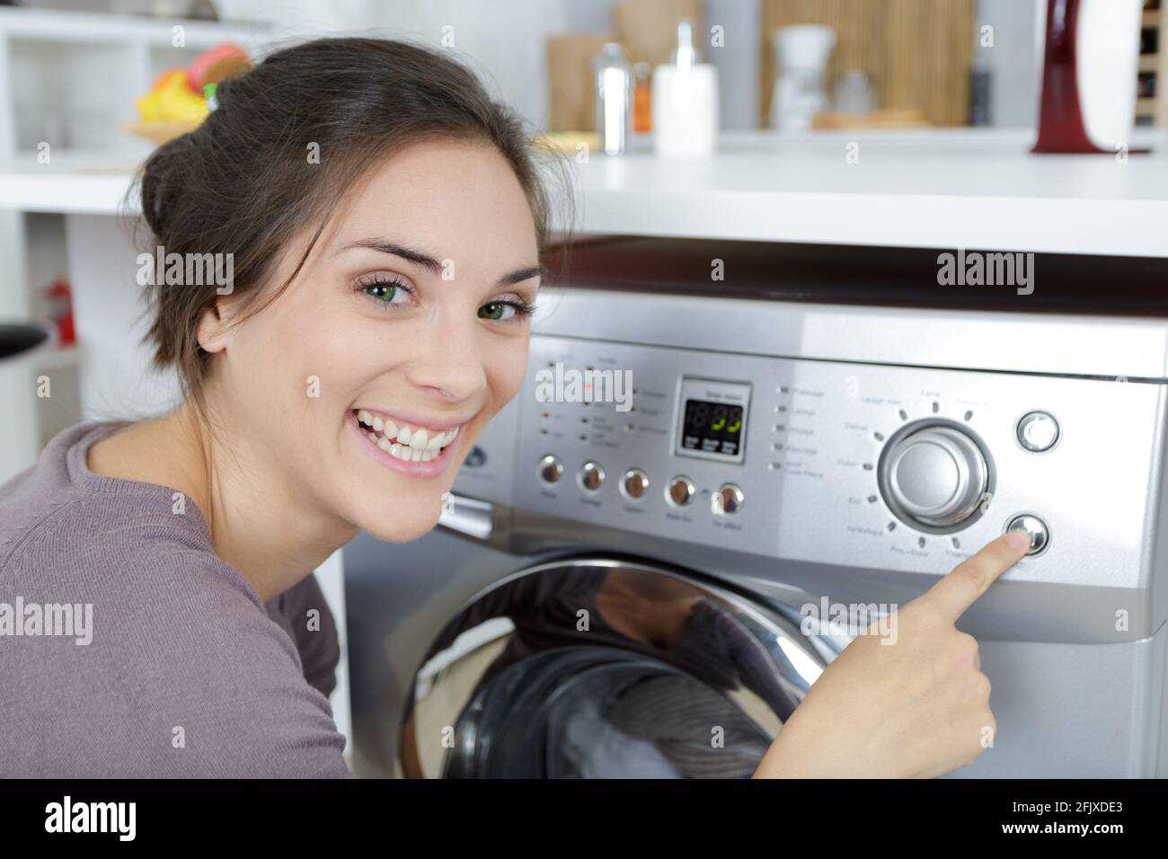 happy woman housewife using her washing machine Stock Photo - Alamy