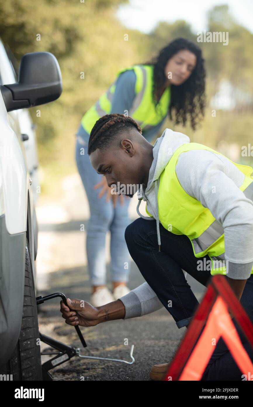 handsome young man lifting the car Stock Photo - Alamy