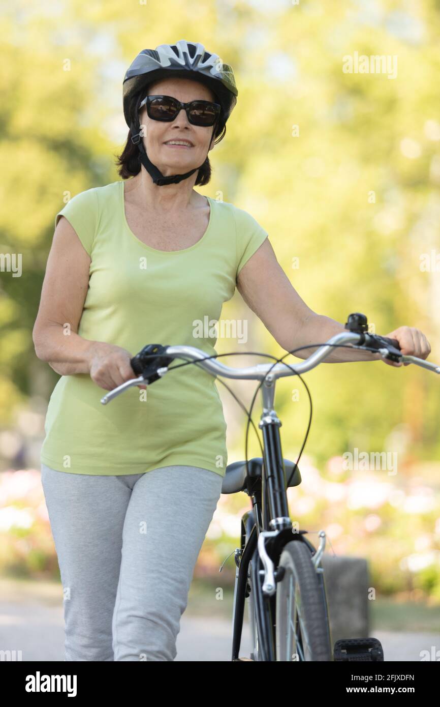 Woman pushing a bicycle hi-res stock photography and images - Alamy