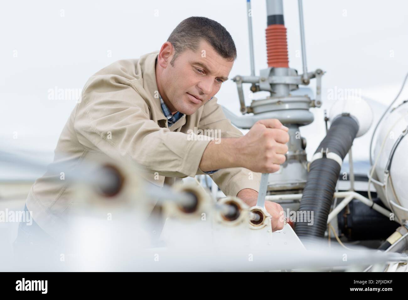 a man fixing an aiplane Stock Photo - Alamy