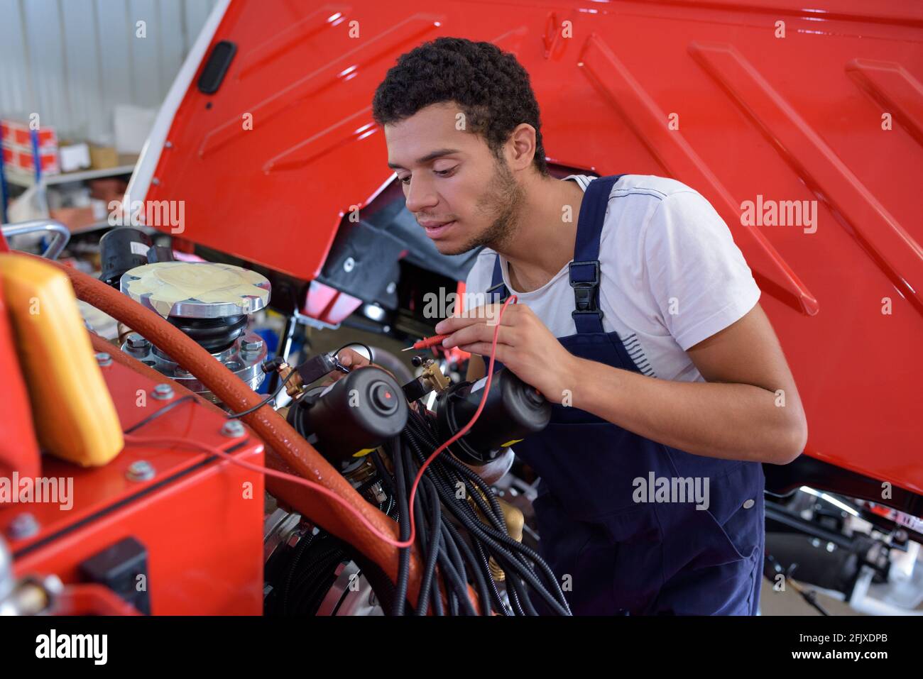 a young mechanic using multimeter Stock Photo - Alamy