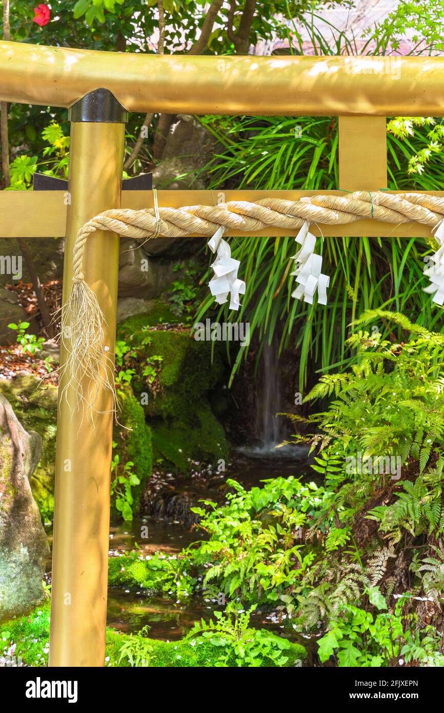 Close up on a Japanese golden gate named torii adorned with a sacred ...