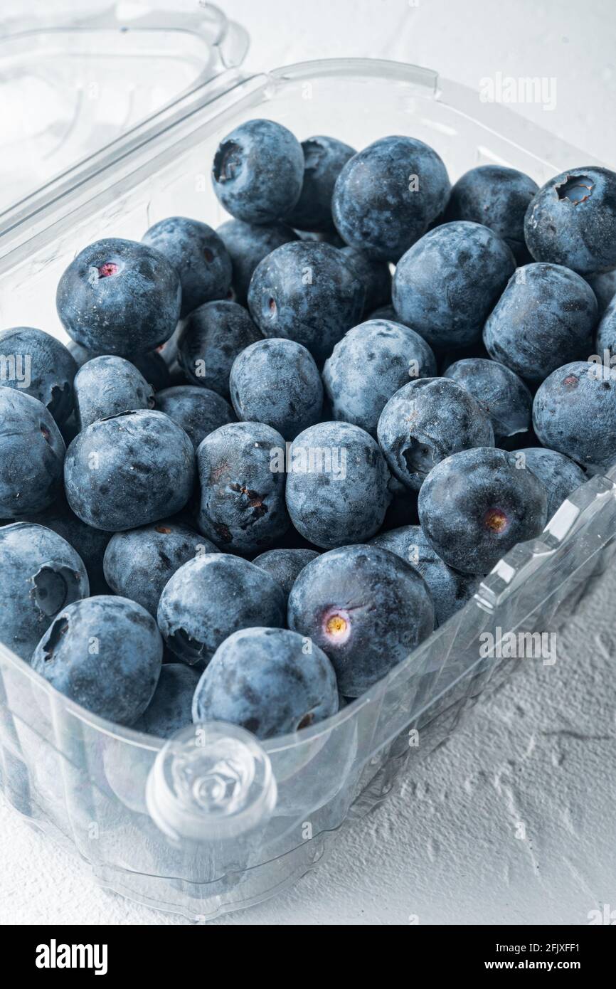 Blueberries, in clear plastic tray, on white background Stock Photo - Alamy