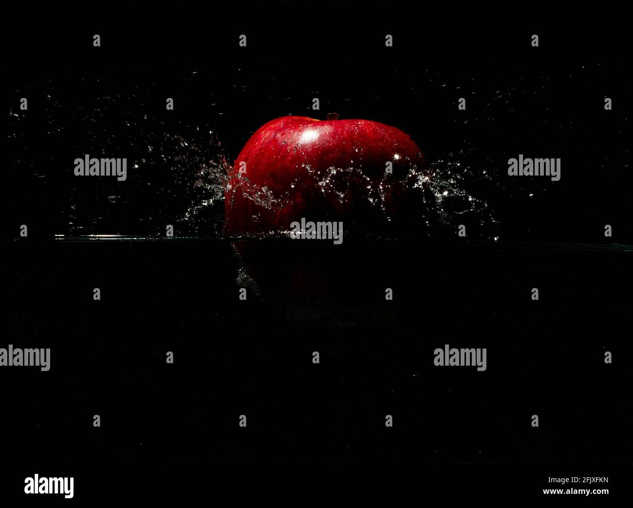 splash apple with black background Stock Photo - Alamy