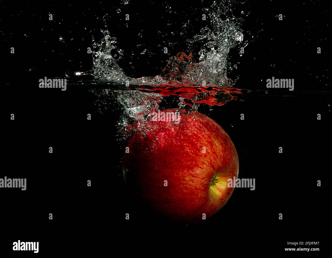 splash apple with black background Stock Photo - Alamy