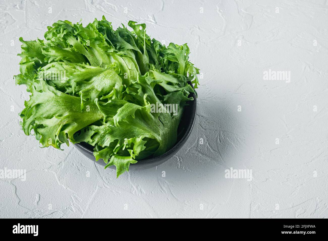 Fresh organic green batavia lettuce leaves, on white background with ...