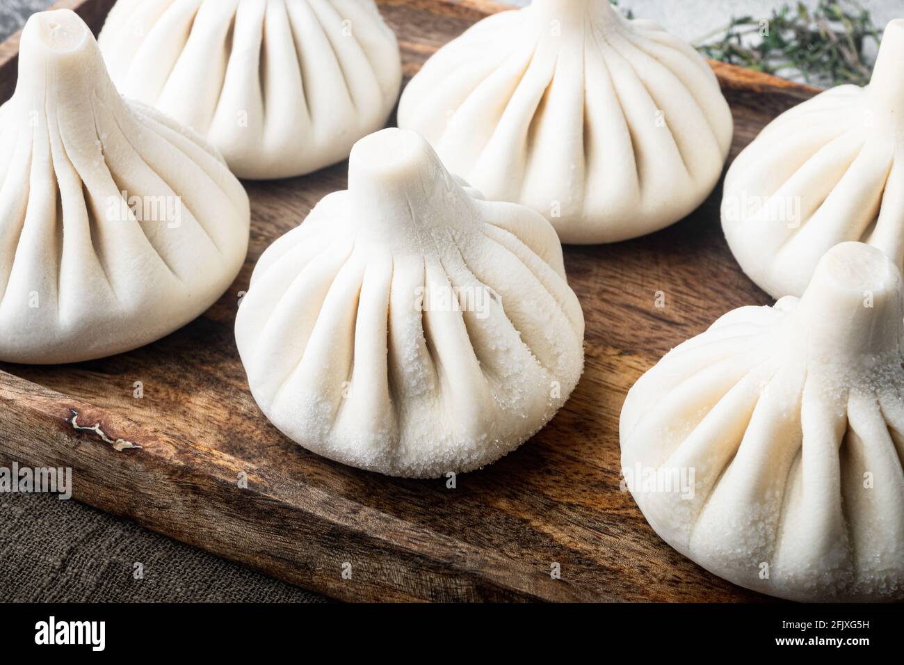 Delicious baozi, Chinese steamed meat bun set, on gray stone background ...