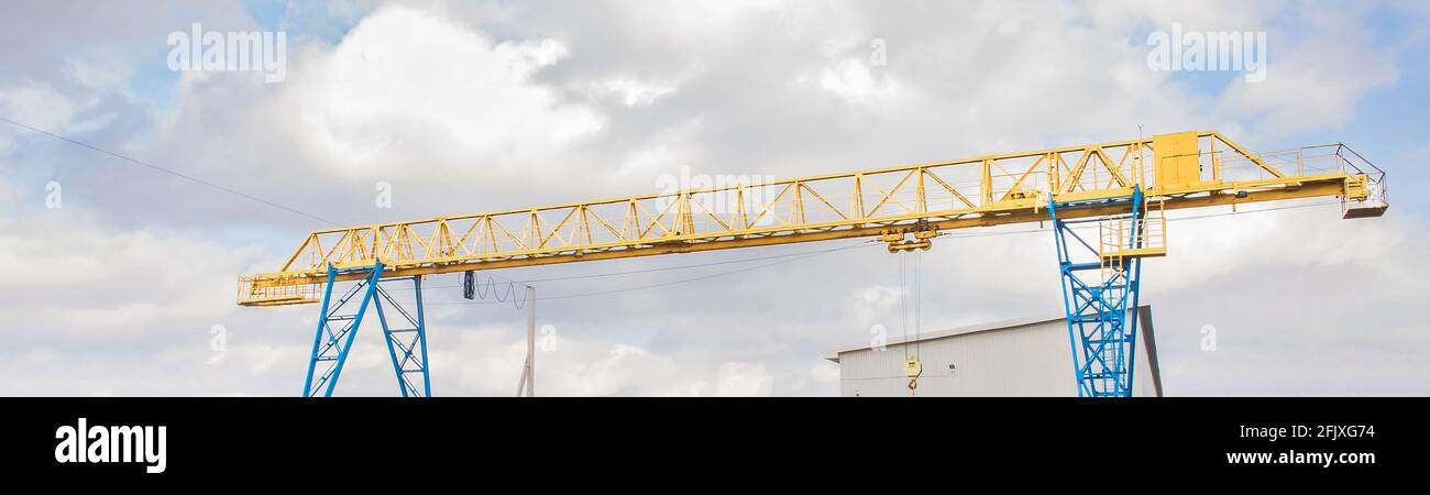Industrial overhead hoisting construction crane on a background of blue ...