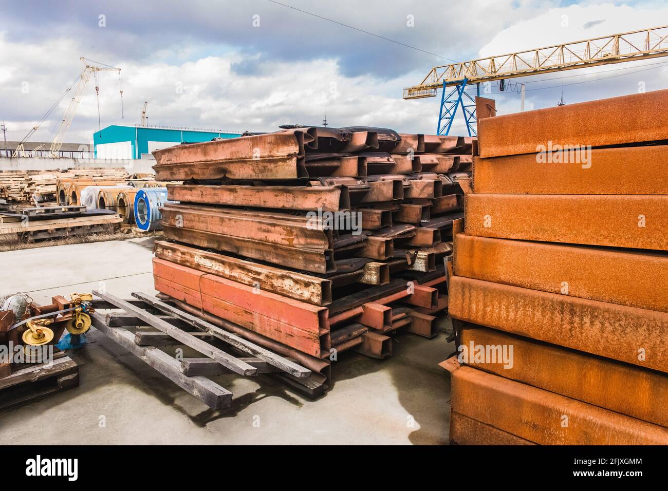 Storage of old rusty metal materials on an open construction site near ...