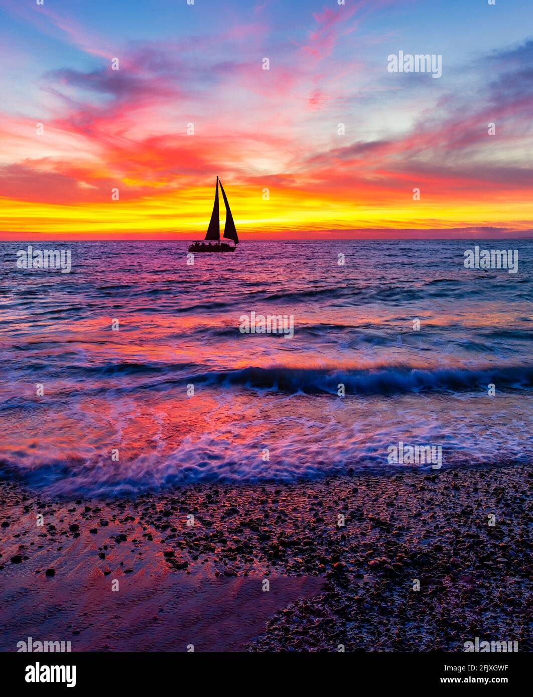 A Colorful Ocean Sunset Sky as a Gentle Wave Rolls to Shore In A ...