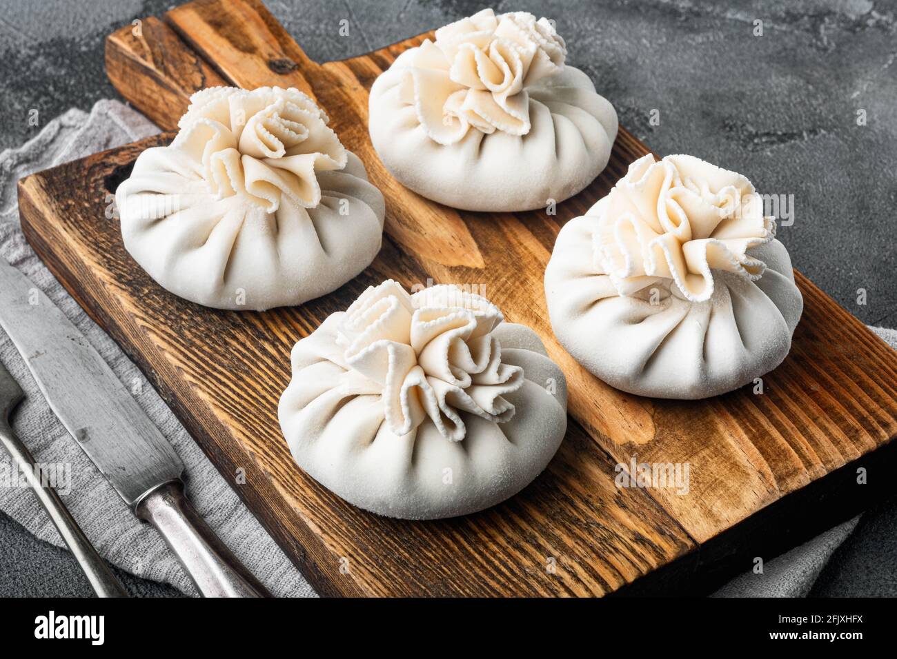 Delicious baozi, Chinese steamed meat bun set, on gray stone background ...