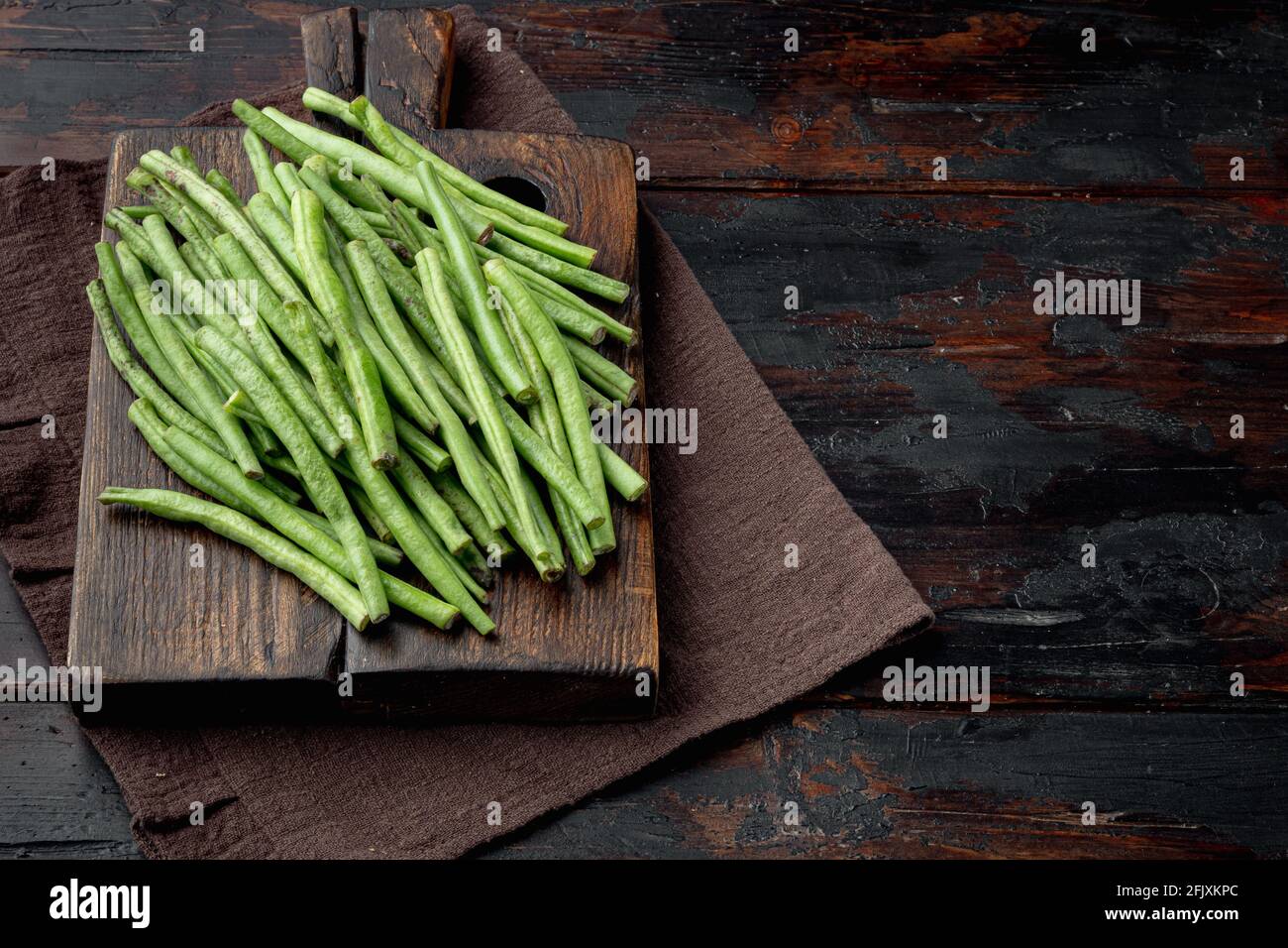 Green french beans cooking set, on wooden cutting board, on old dark ...