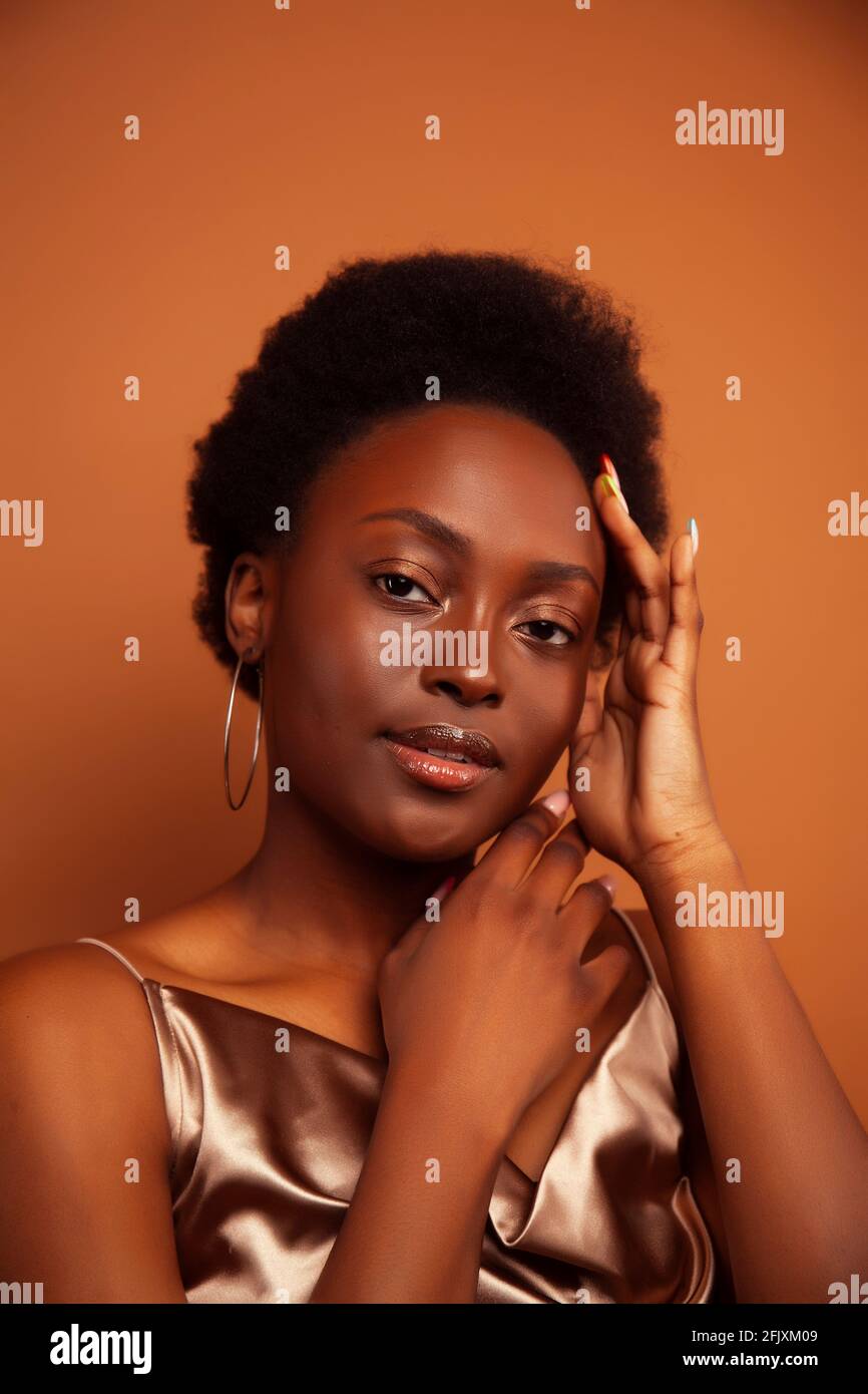 pretty young african american woman with curly hair posing cheerful ...