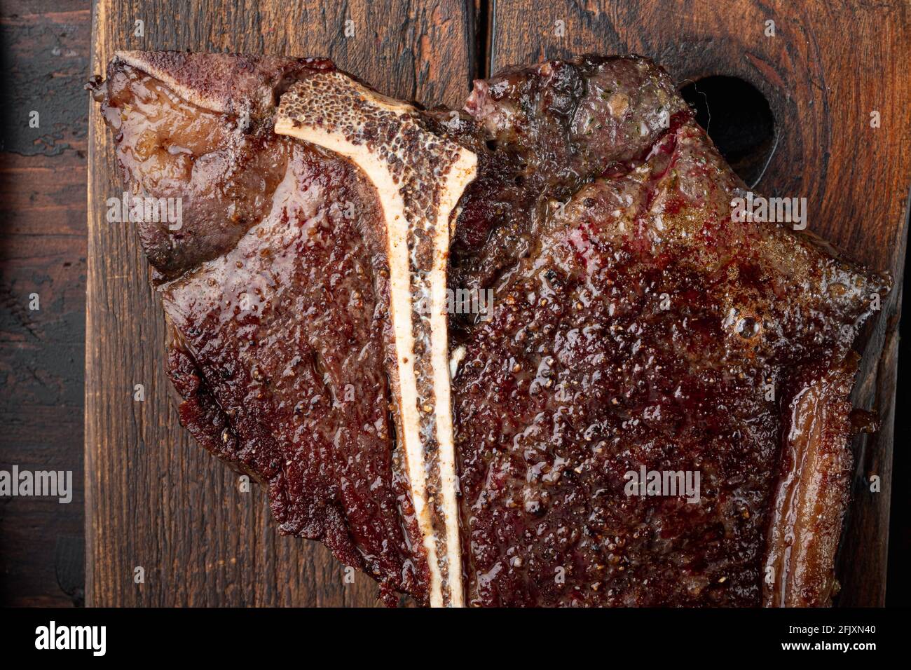 Dry Aged Barbecue Porterhouse Steak T-bone set, on wooden serving board ...