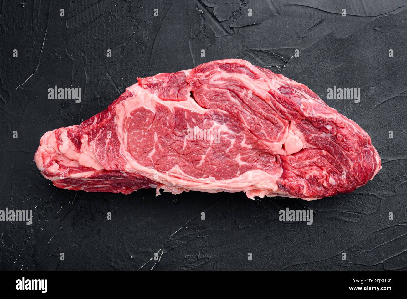 Raw beef meat set, on black stone background, Rib eye cut, top view ...
