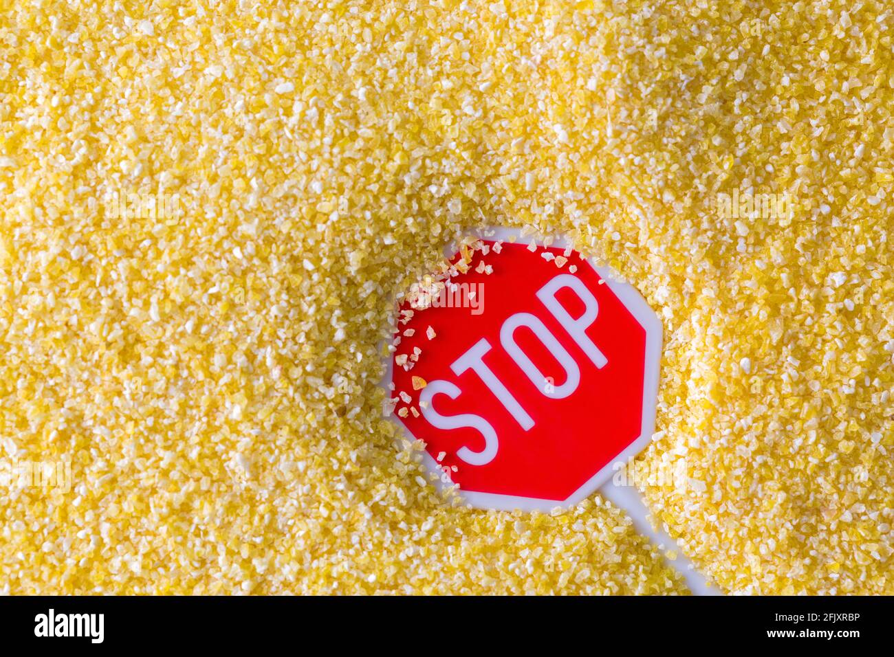 Stop sign on texture of Polenta, yellow Cornmeal flour, Semolina, fast ...