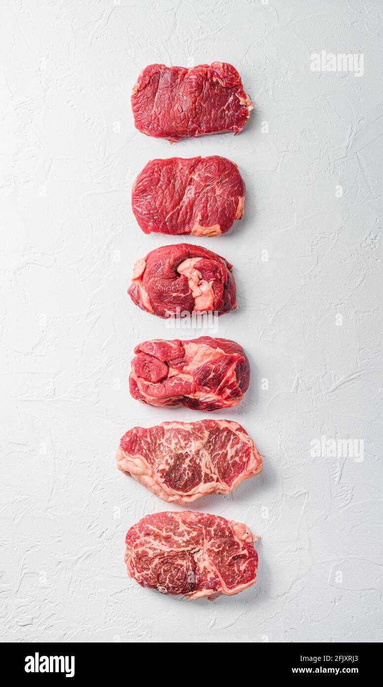 Rraw beef steaks set top blade, rump, chuck eye roll over white ...