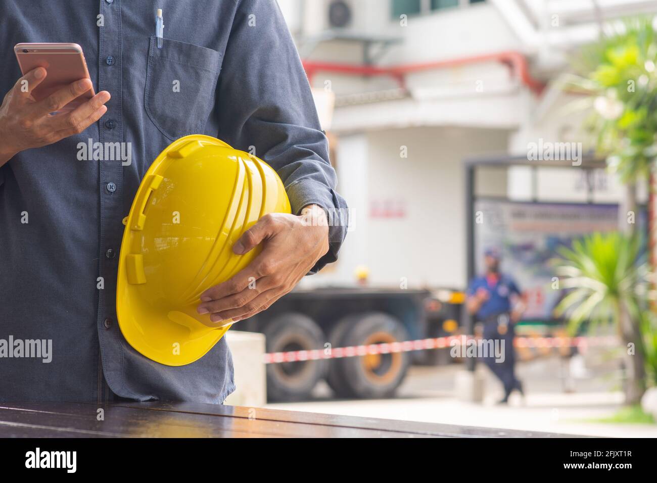 Engineer worker holding yellow helmet hard hat safety car truck ...