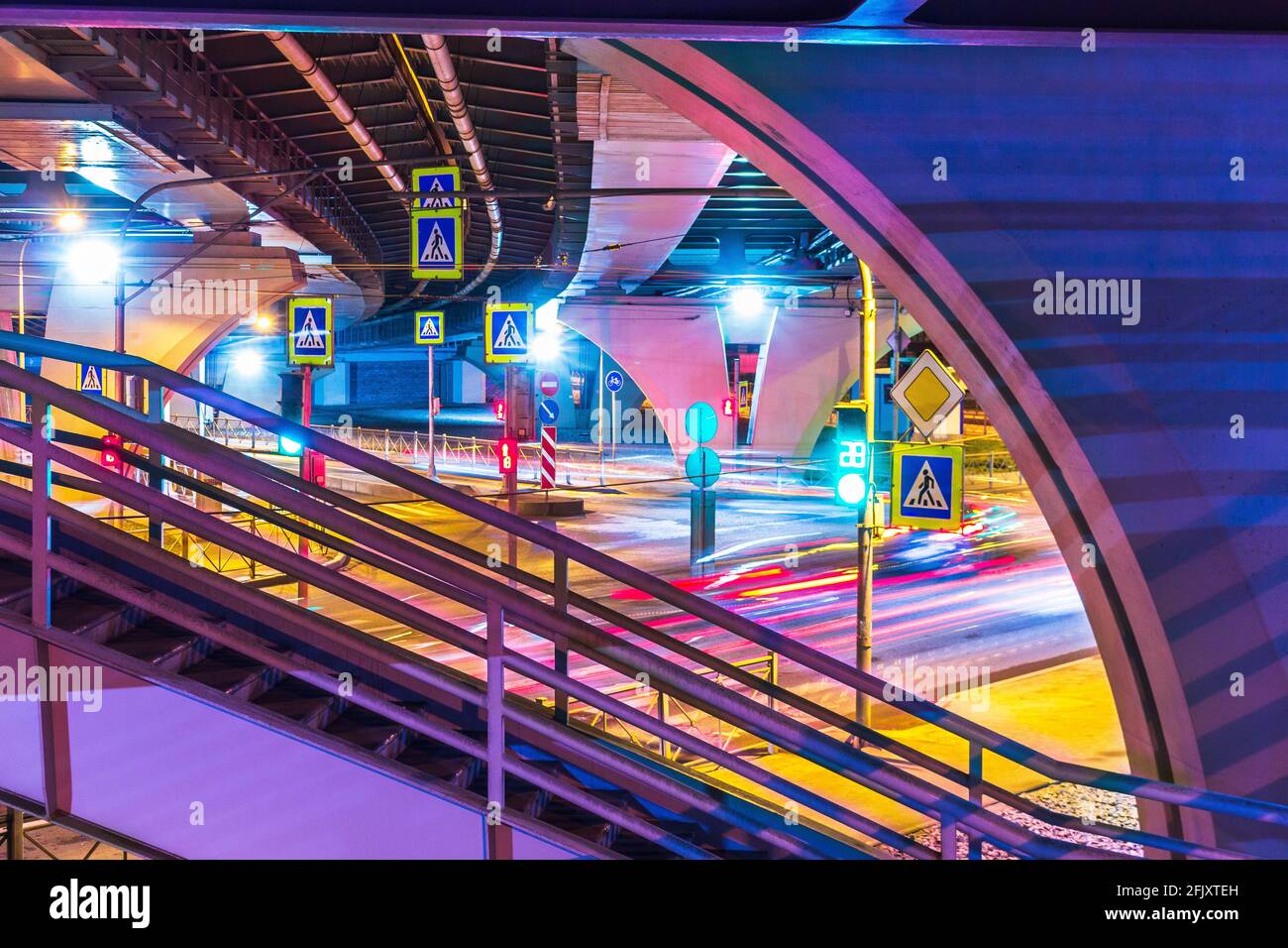 Crossroads traffic lights at night and aboveground pedestrian crossing ...